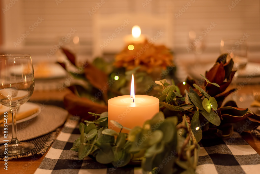 Cozy dinner table setting by candlelight Stock Photo | Adobe Stock