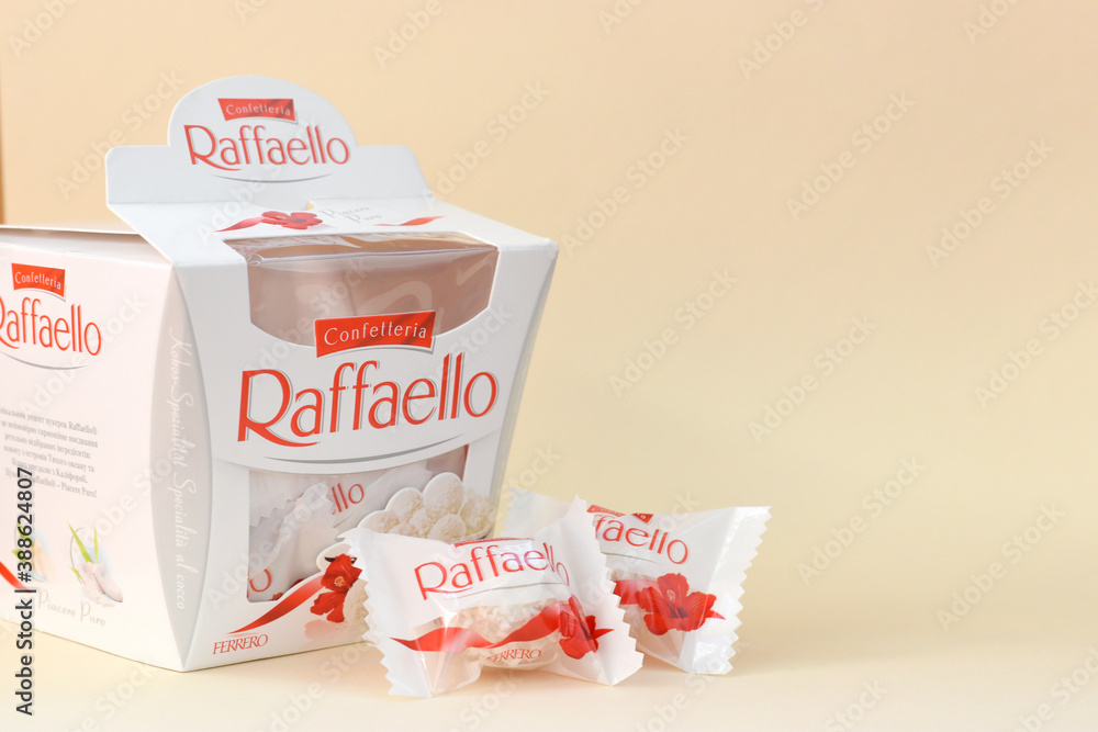 Raffaello candies on beige background. Raffaello is a spherical coconut ...