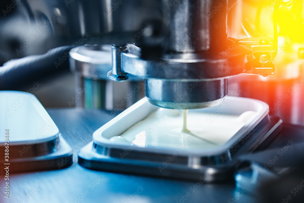 Food production, dairy plant. Automated filling of yoghurt into ...