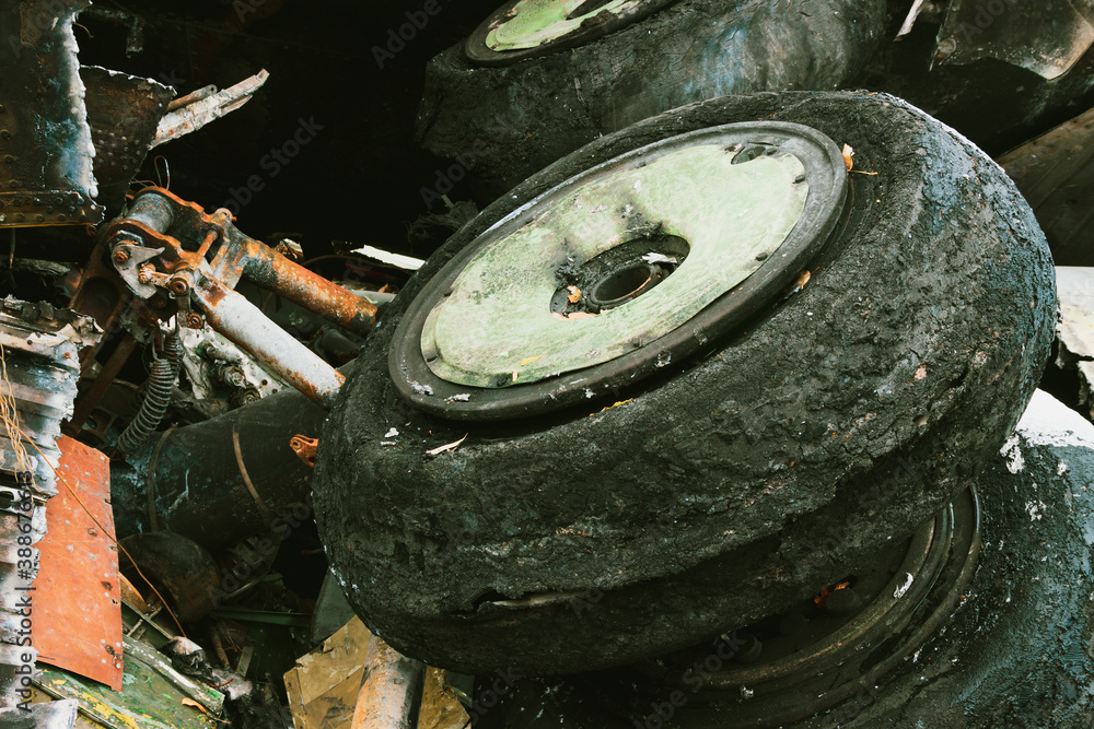 Plane wreckage, parts of the fuselage and landing gear with the wheel ...