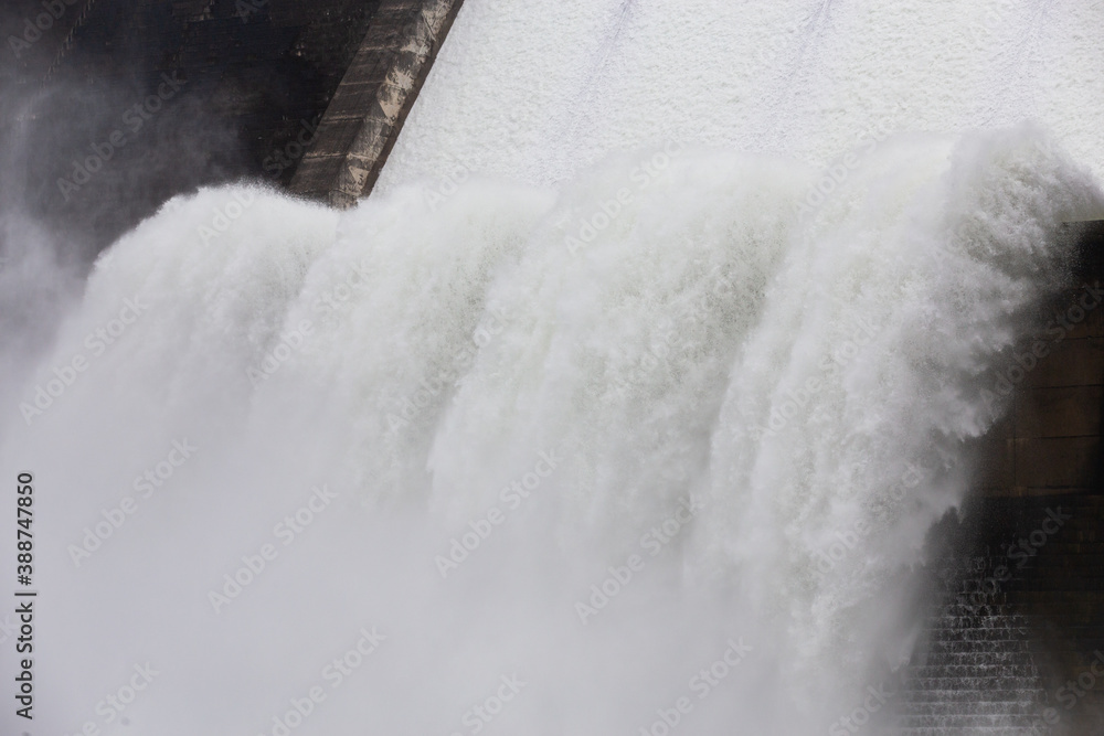 Water falling from the spillway of the concrete dam, it is overflow way ...