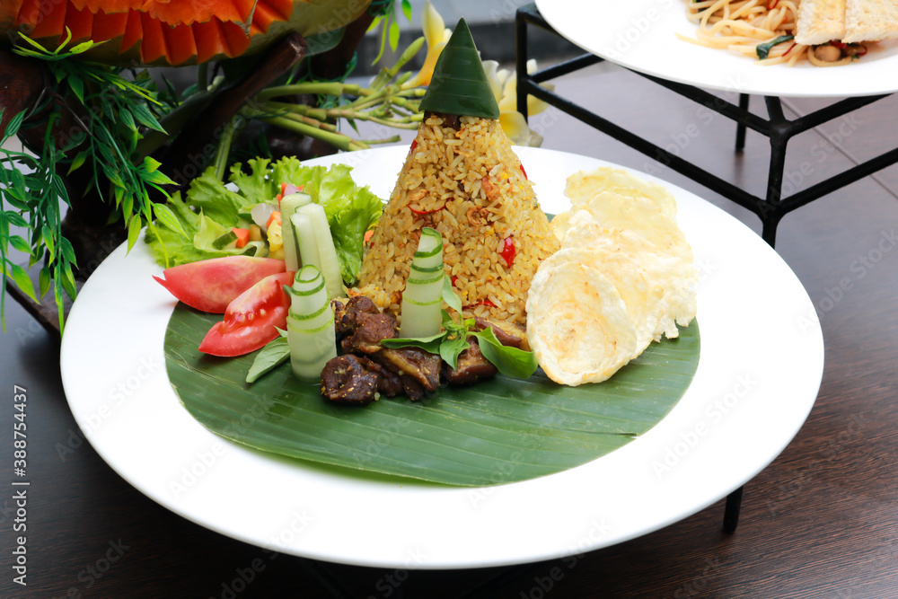 Traditional Indonesian Cuisine Nasi Tumpeng. Tumpeng is a cone-shaped ...