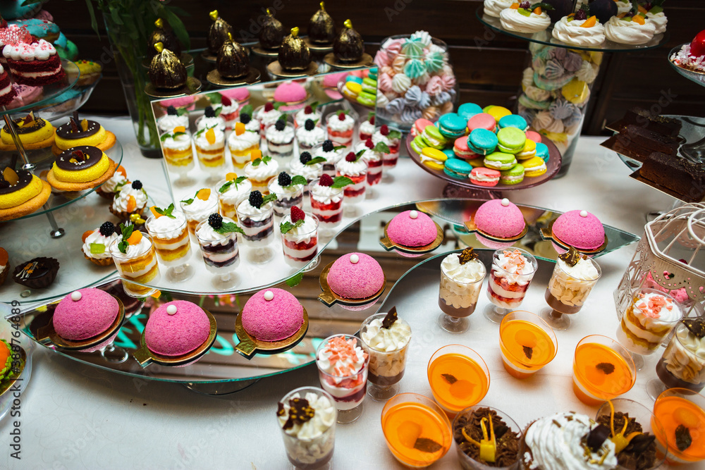 Candy bar. Delicious holiday reception on dessert table. Festive table ...