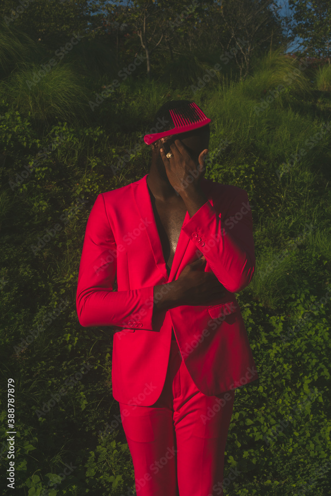 Man In Pink Suit Covering Face Stock Photo | Adobe Stock