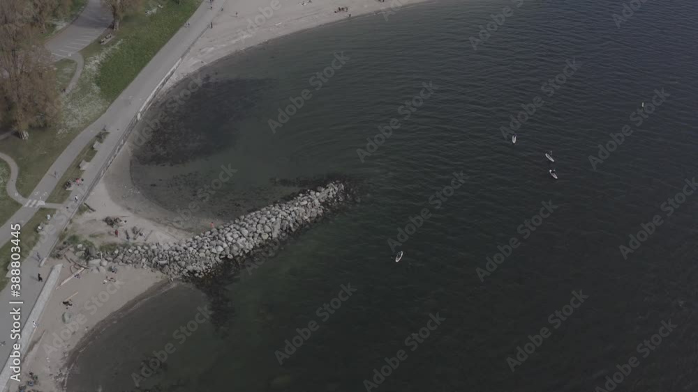 Aerial drop over English Bay Sunset Beach birds eye view of paddle ...