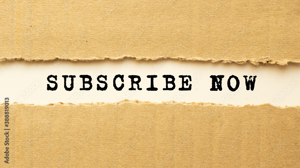 Text SUBSCRIBE NOW appearing behind torn brown paper. Top view. Stock ...