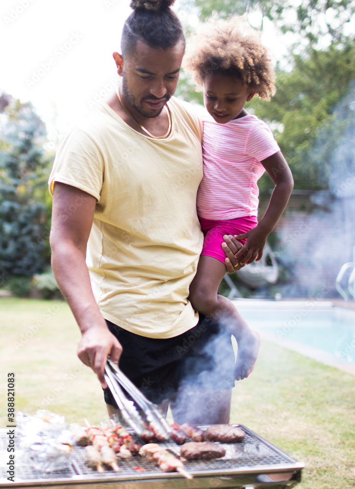Father holding daughter at barbecue grill in summer backyard Stock ...