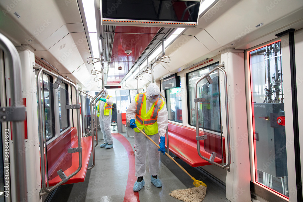 Workers in clean suits sanitizing and mopping subway Stock Photo ...