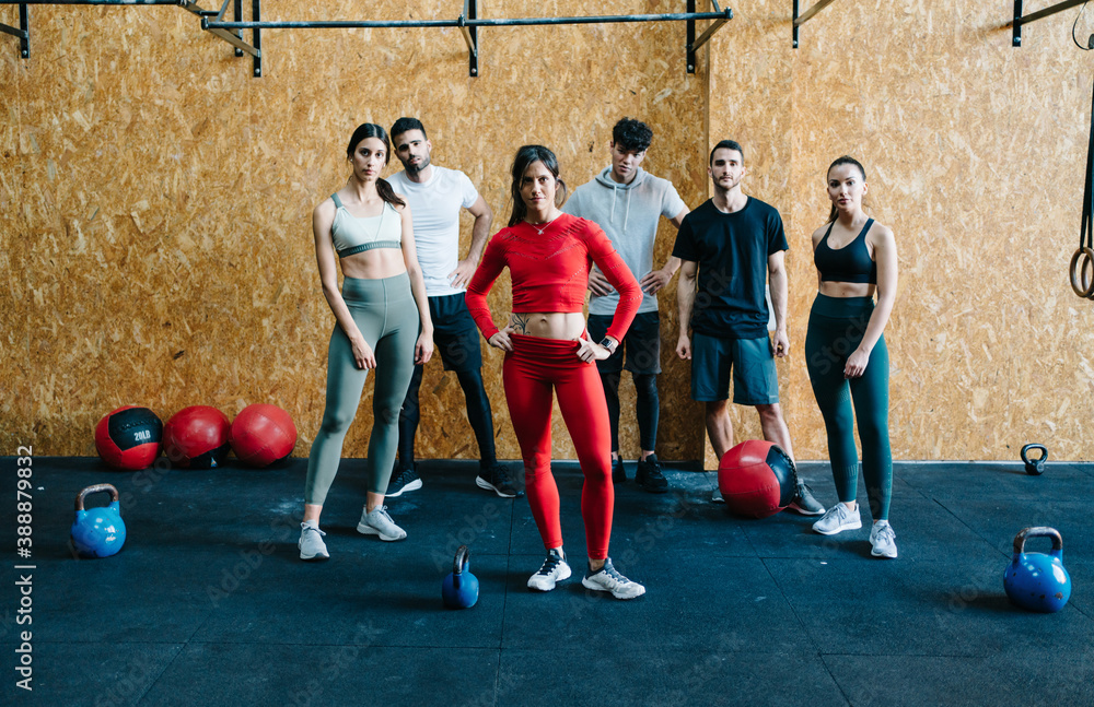 Coach with athletes in gym Stock Photo | Adobe Stock
