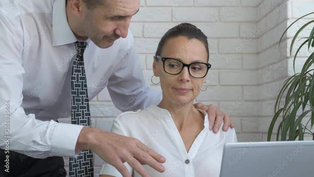 Communication at work. The man puts his hands on the shoulder of the ...