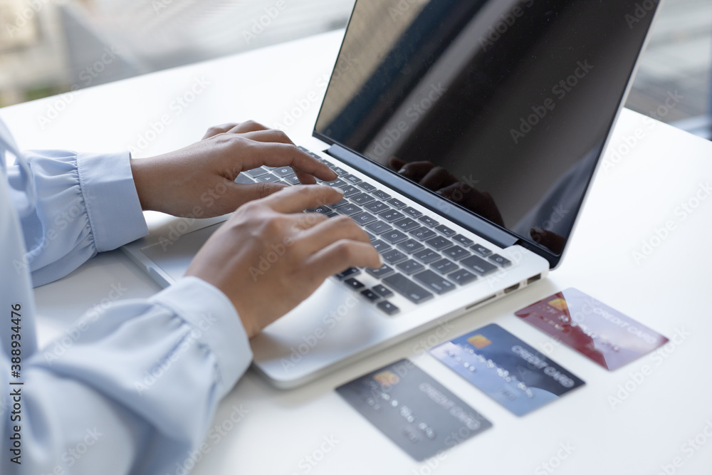Women use laptop register via credit cards to make online purchases ...