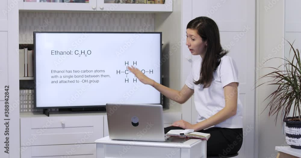 Female teacher gives chemistry online lesson via internet with tv ...