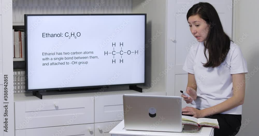 Female teacher gives chemistry online lesson via internet with tv ...