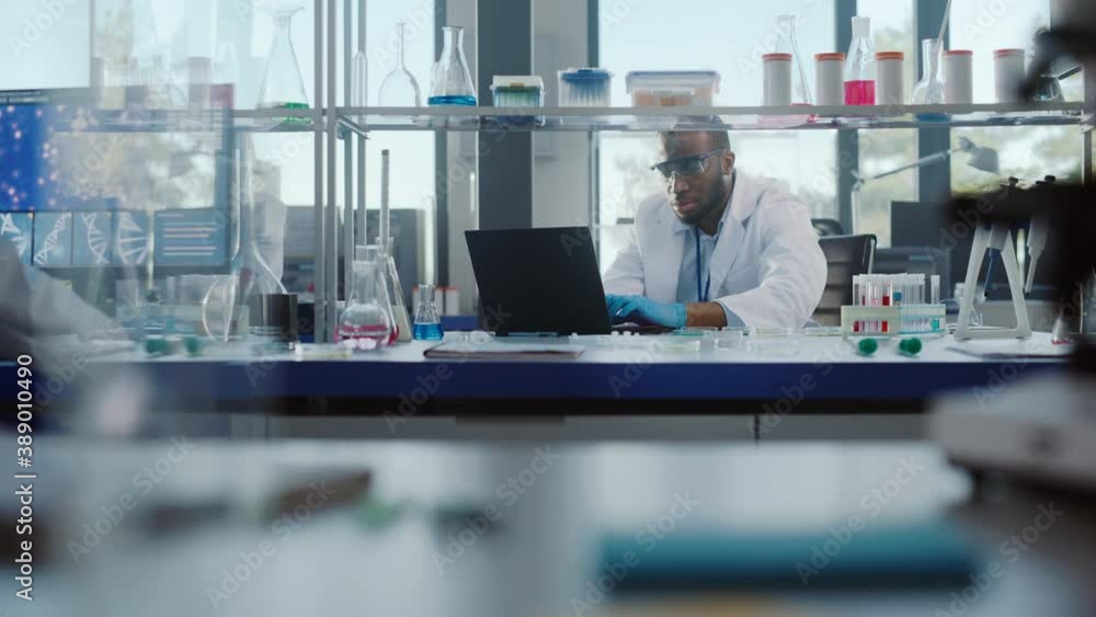 Handsome Male Medical Scientist Wearing A White Coat and Safety Glasses ...
