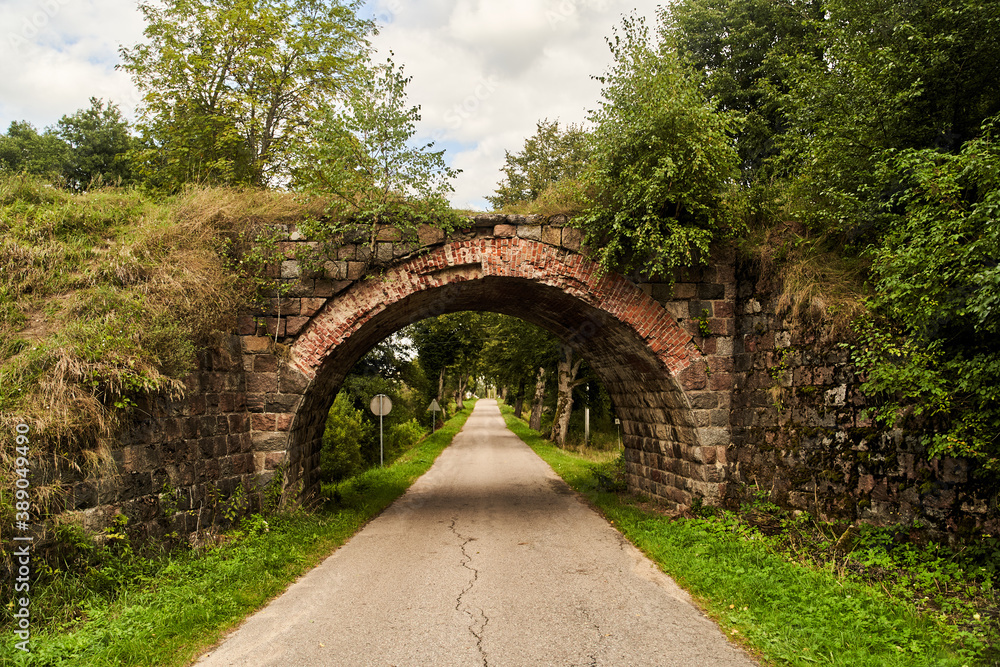 Old German bridge across the road. The bridge of the Rominten Forest ...