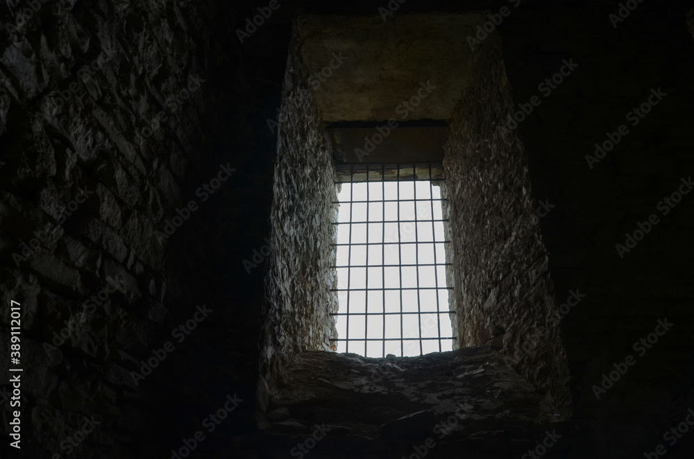 Window in old prison cell. Metal bars in jail. Medieval prison with iron bars. Security grids in ...