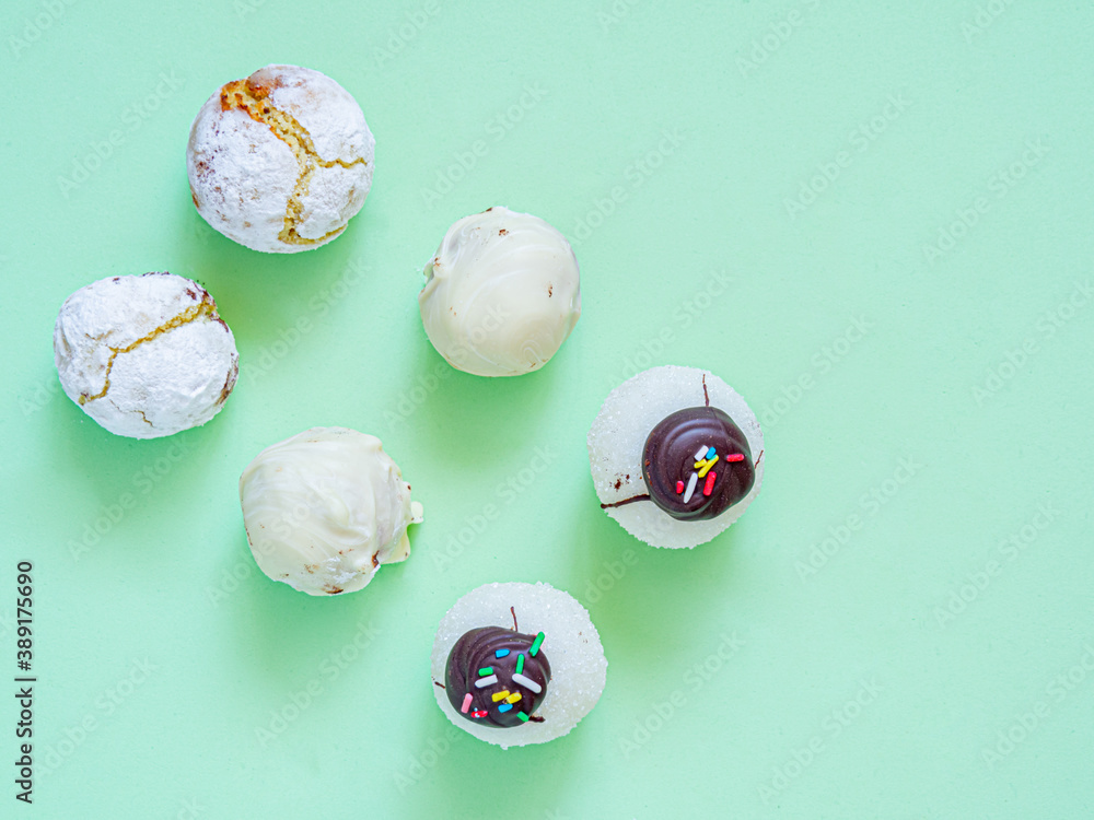 Assortment of white comfit and sweets in green background for dessert ...