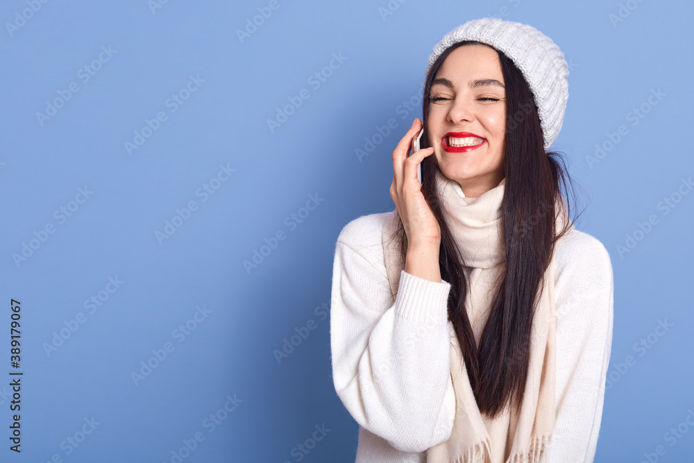 Cheerful pretty brunette girl talking on phone and laughing carefree ...