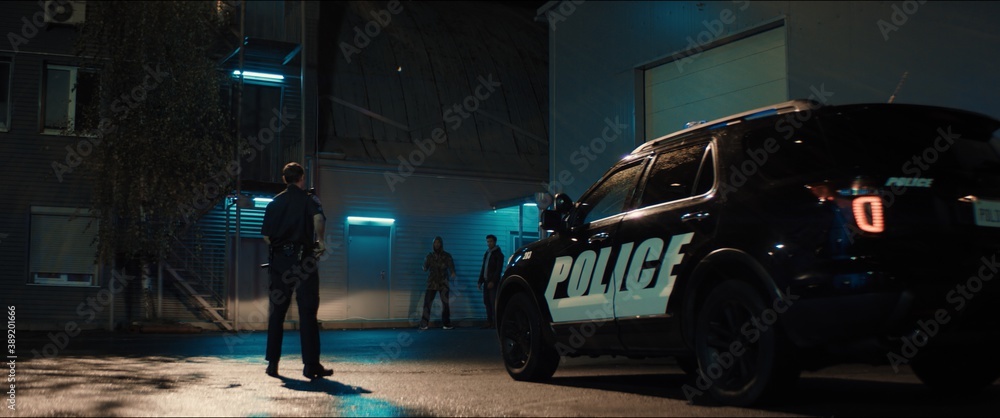 WIDE Police officer exiting a car and approaching two multi-ethnic ...
