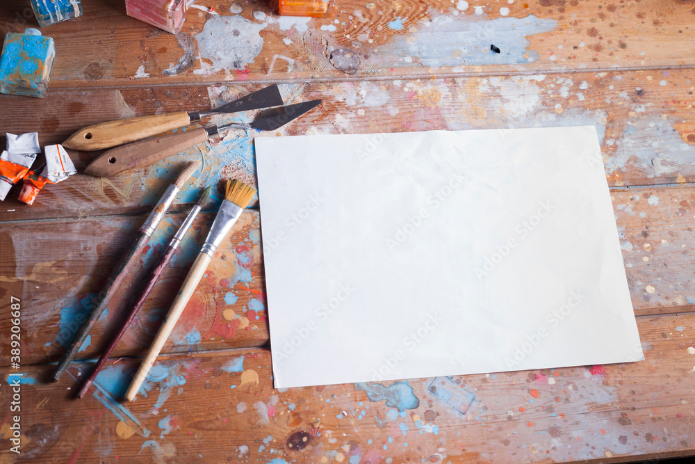 Artist desk and materials mockup.Various brushes,pallete knives and ...