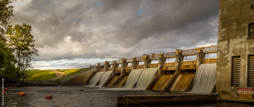 Water flowing over Barton dam on a cloudy morning Stock Photo | Adobe Stock