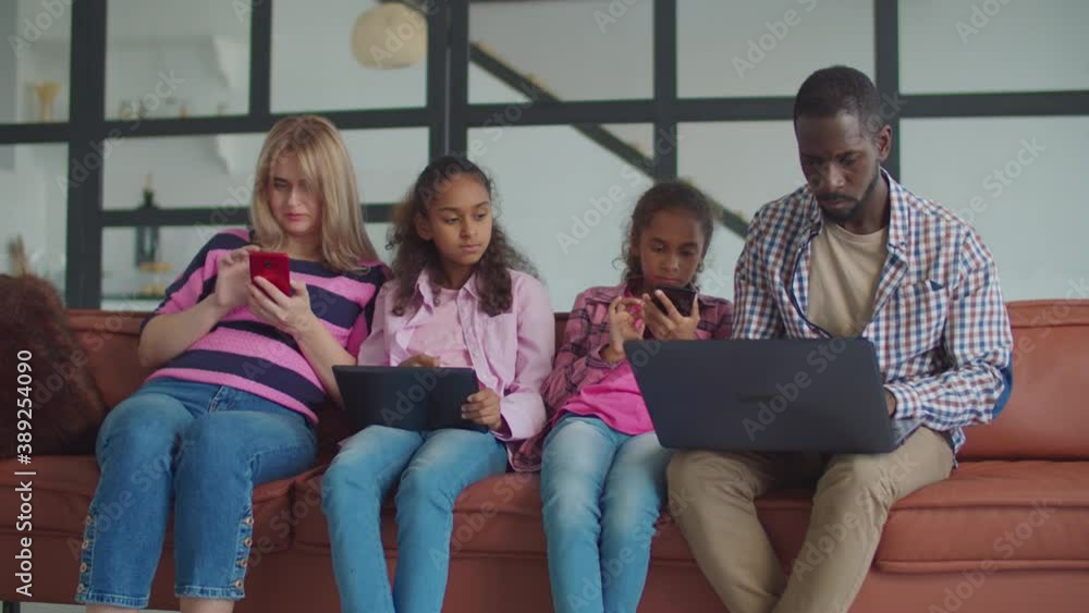Addicted to modern smart technology devices multiracial family with two ...