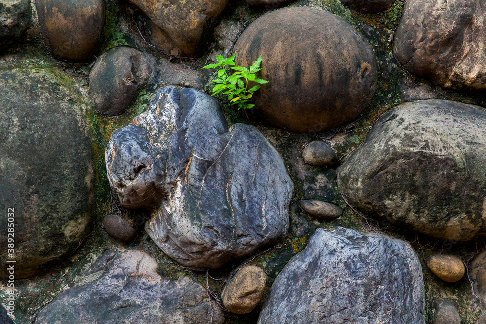 The texture of an ancient Chinese stone wall made of huge round ...