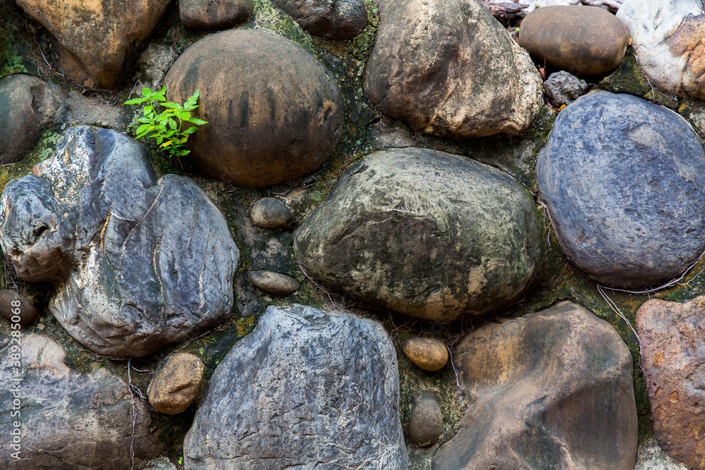 The texture of an ancient Chinese stone wall made of huge round ...