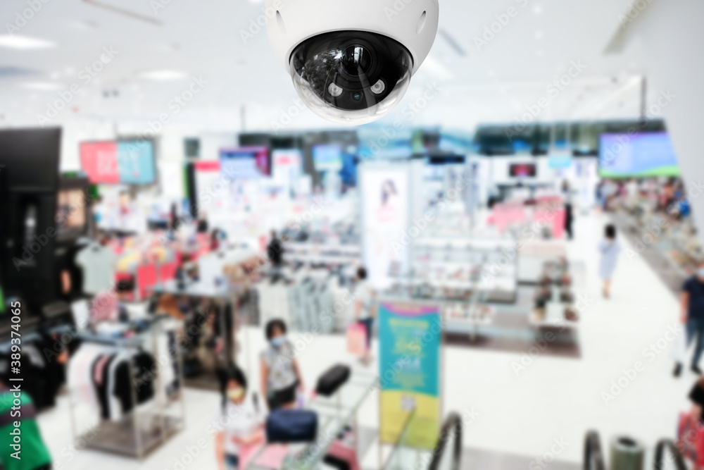 Modern public CCTV camera with blur interior shopping mall background ...