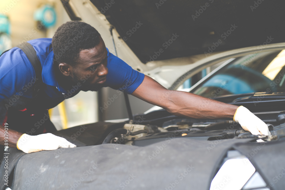 Male Mechanic Under Car
