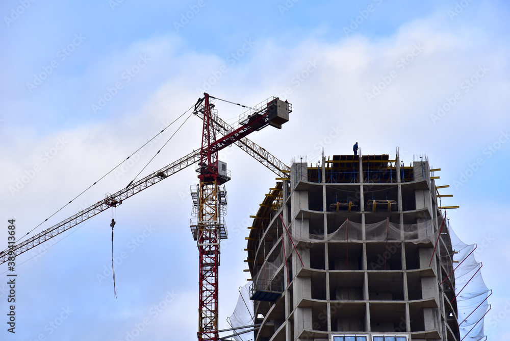 Tower cranes in action at construction site. Construction of skeleton ...