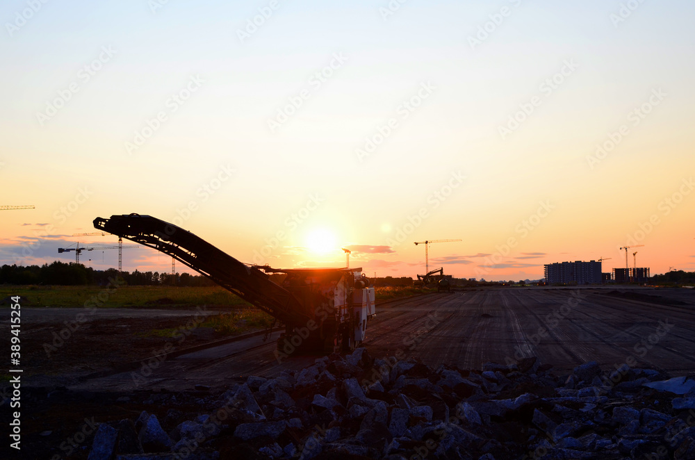 Cold milling machine on sunset background. Heavy equipment for the ...