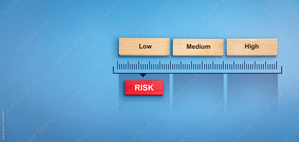 Risk meter concept with text high, medium, low and risk wooden block ...