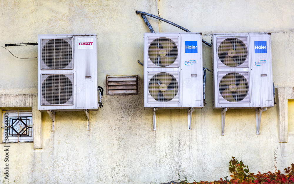 Different air compressors hanged on the wall Stock Photo | Adobe Stock