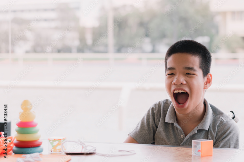 Asian Special need child on wheelchair smile and interested in skills ...