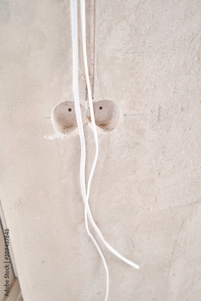 Holes in a concrete wall for installing plastic boxes under sockets ...