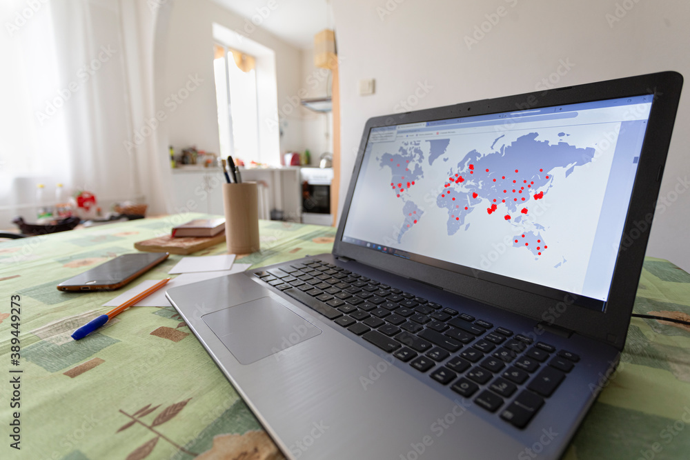 Distribution map Covid-19 on world map on computer in home office ...