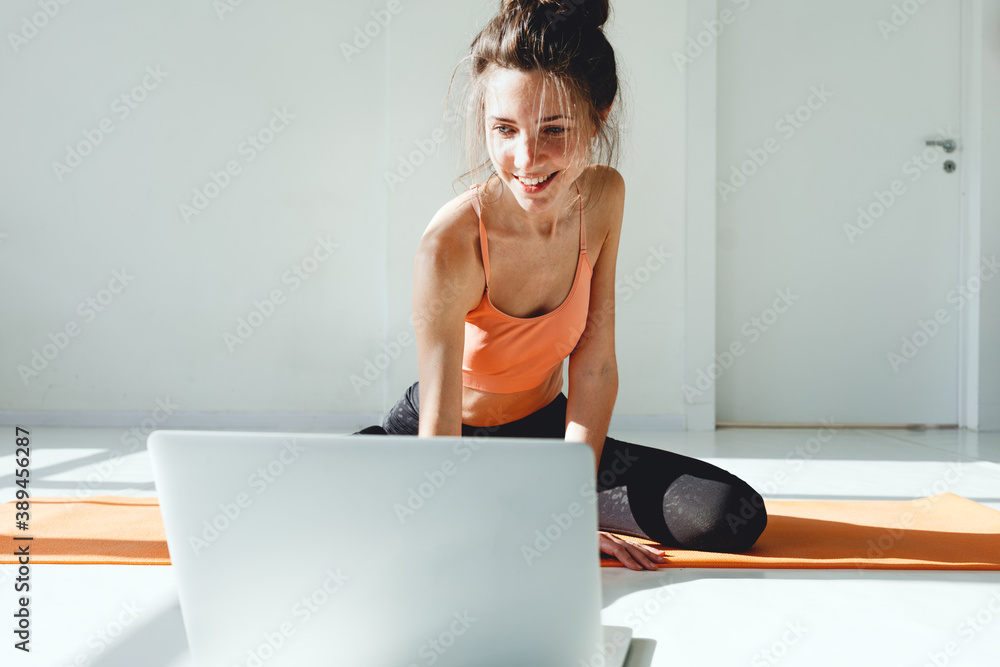 Fitness trainer taking online yoga lesson for people at home on video ...
