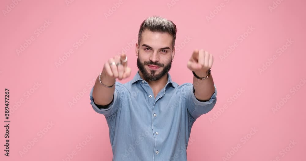 young casual man with crossed arms is laughing, gesturing hey you, call ...