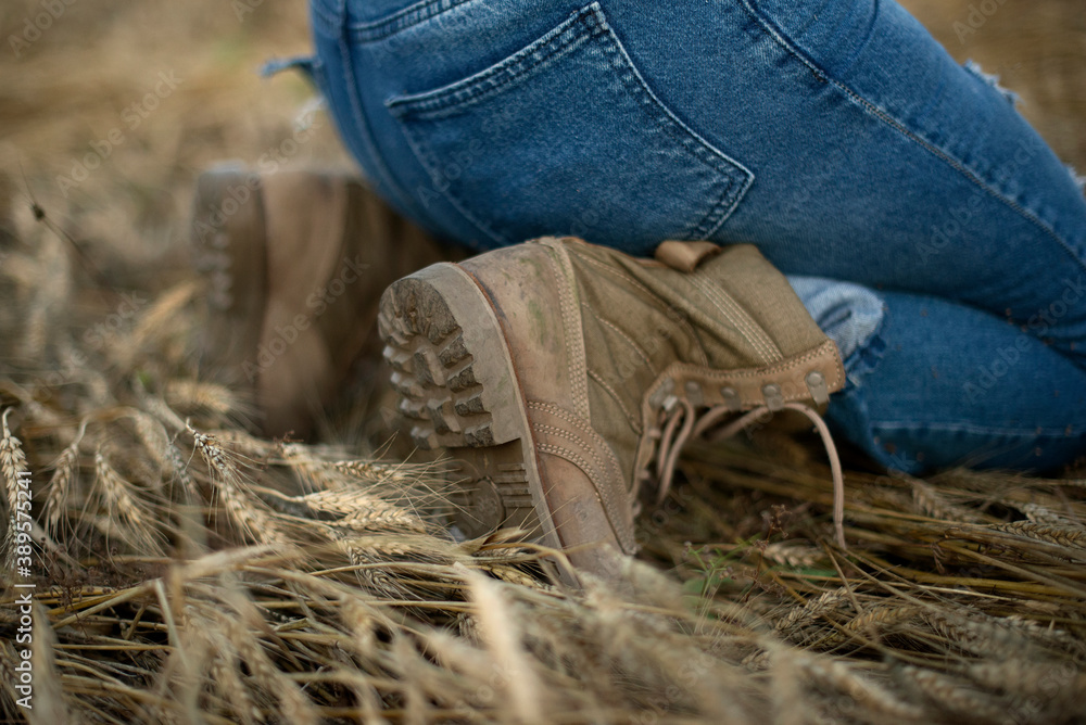 Strip of boots on feet with spikelets on the ground. Cowboy boots and ...