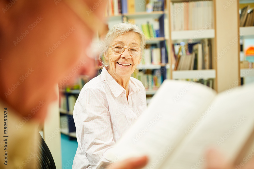 Happy senior citizen in a library Stock Photo | Adobe Stock