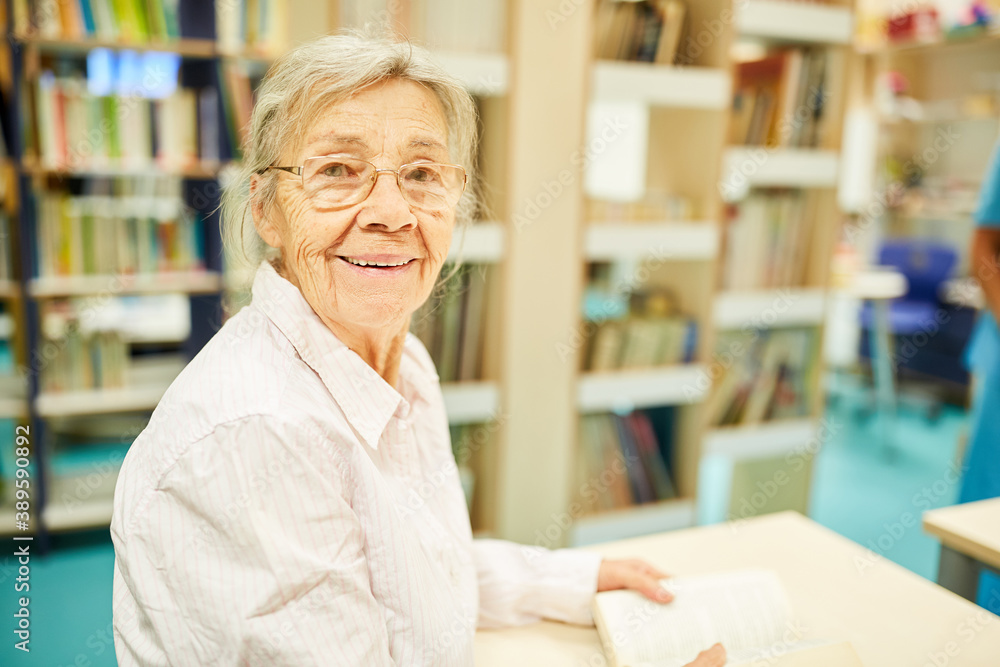 Old woman as a librarian in a library Stock Photo | Adobe Stock