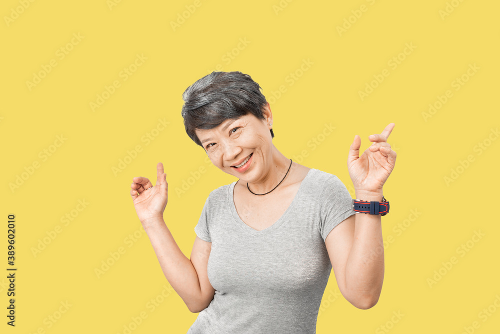 A happy middle-aged Asian gray-haired woman, her wrinkled face smile ...