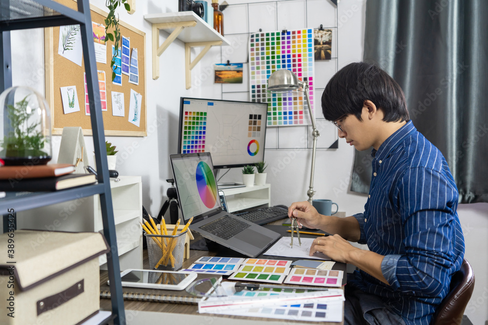 Asian men Architect or graphic designer designing a layout selection ...