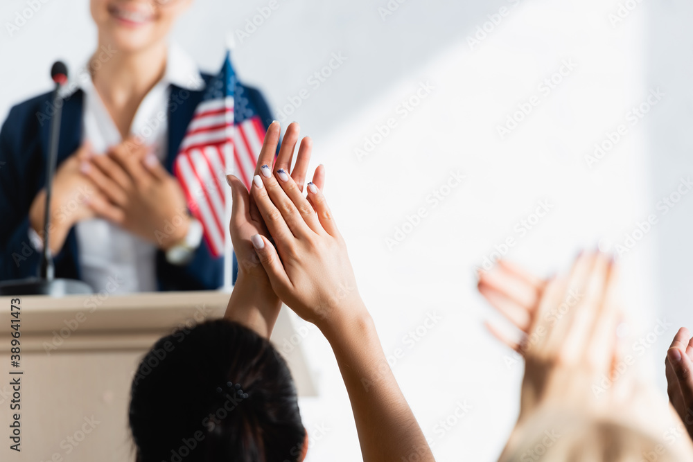 grateful political agitator holding hands on chest in front of voters ...