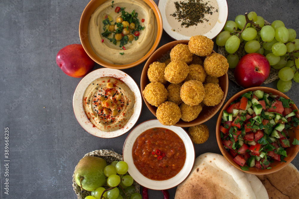 Authentic food of Middle East. Plate of hummus, falafels, pita bread ...