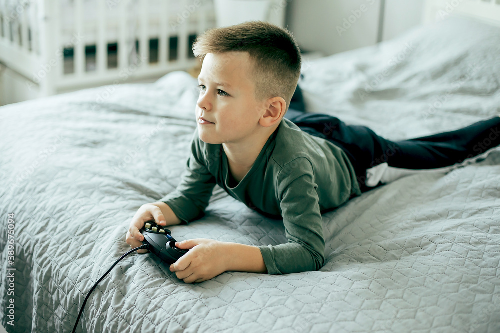 Caucasian little boy playing video games. Lifestyle, leisure concept ...