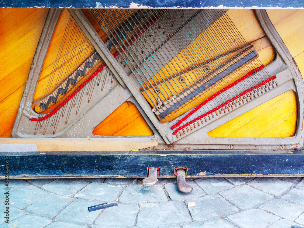 The bottom of an old broken piano with pedals and bare strings Stock ...