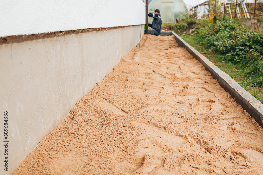 Construction of a blind area of a house from paving slabs - laying ...
