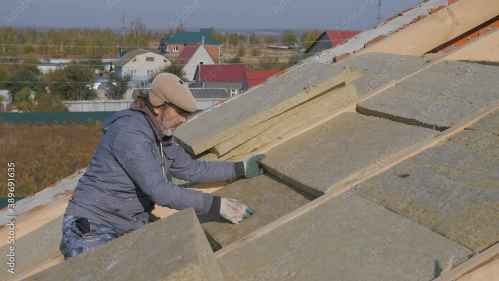 Roofing work. Installation of insulation for insulation of the roof of ...